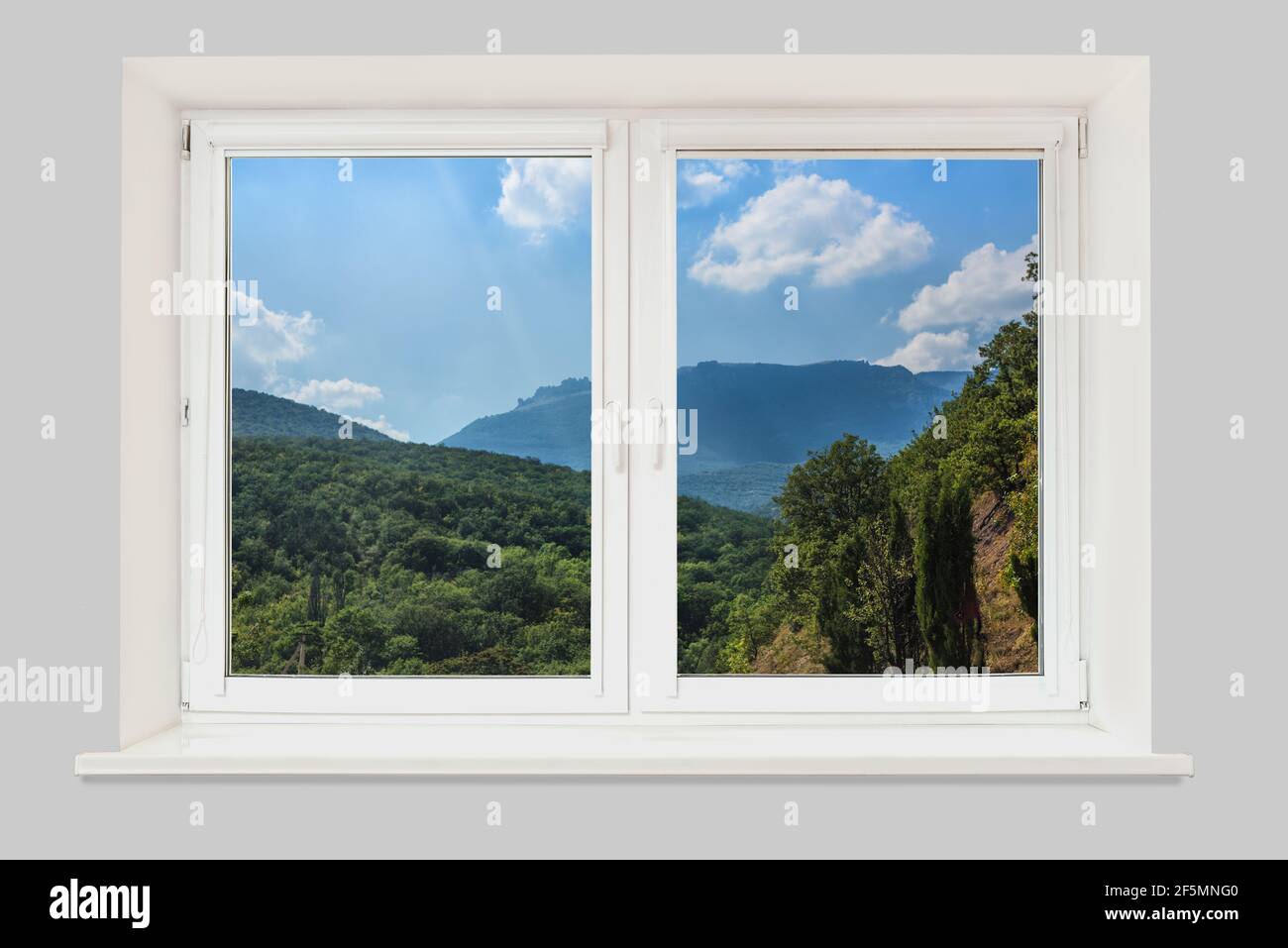 View from the window. Mountain forest landscape under evening sky with ...