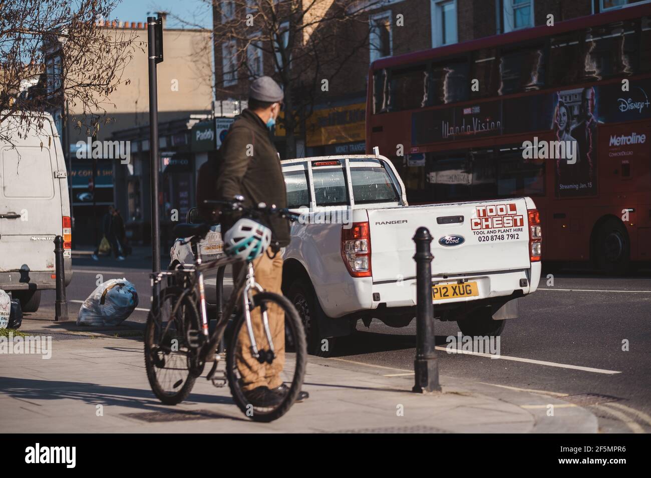 Shepherd's Bush, London | UK - 2021.03.22: Man with the bicycle in the ...