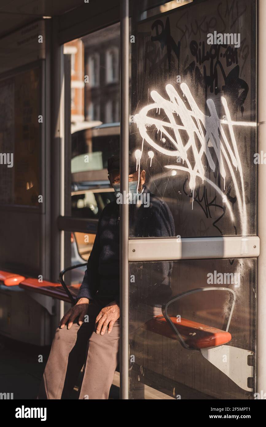 Shepherd's Bush, London | UK - 2021.03.22: Man wearing a mask sitting ...