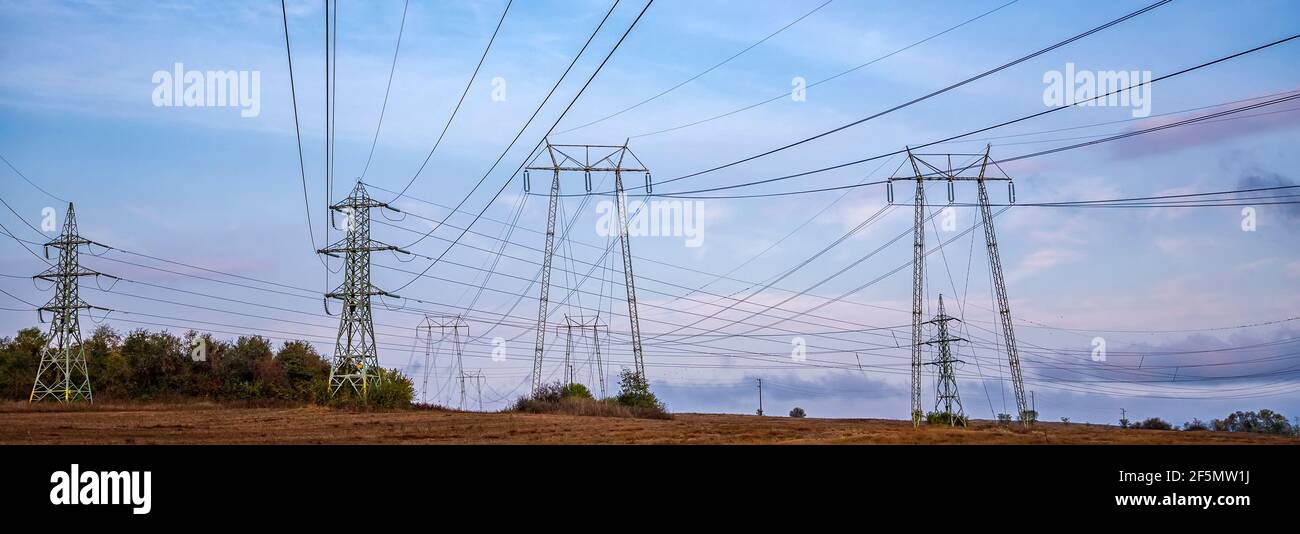 Rows of electrical towers and power lines. Panoramic view Stock Photo ...