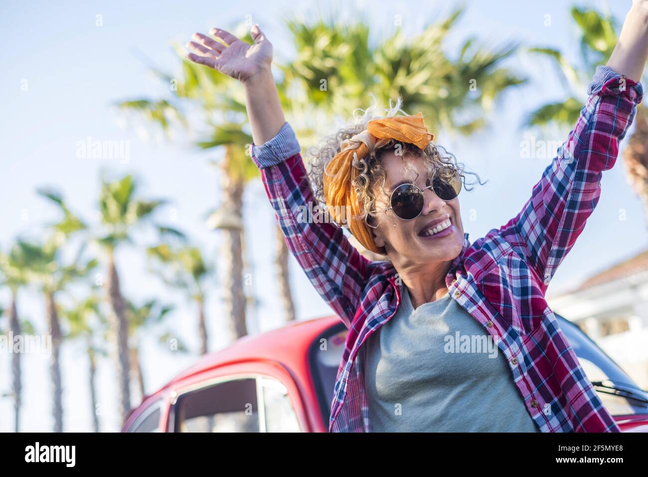 Excited pretty young trendy woman outdoor enjoy summer lifestyle ...