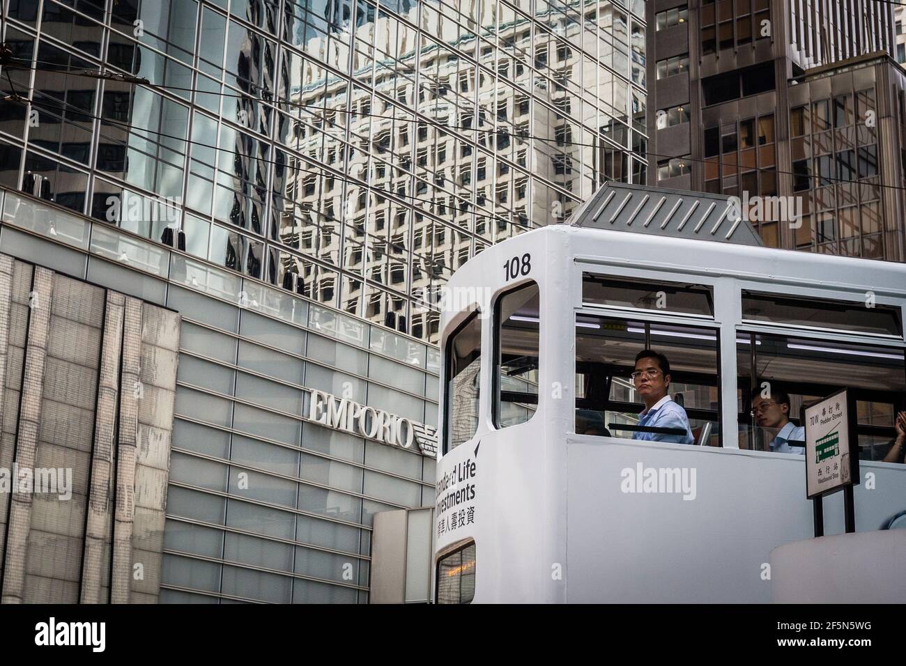Man looking out a ding ding window in Hong Kong business district Stock ...