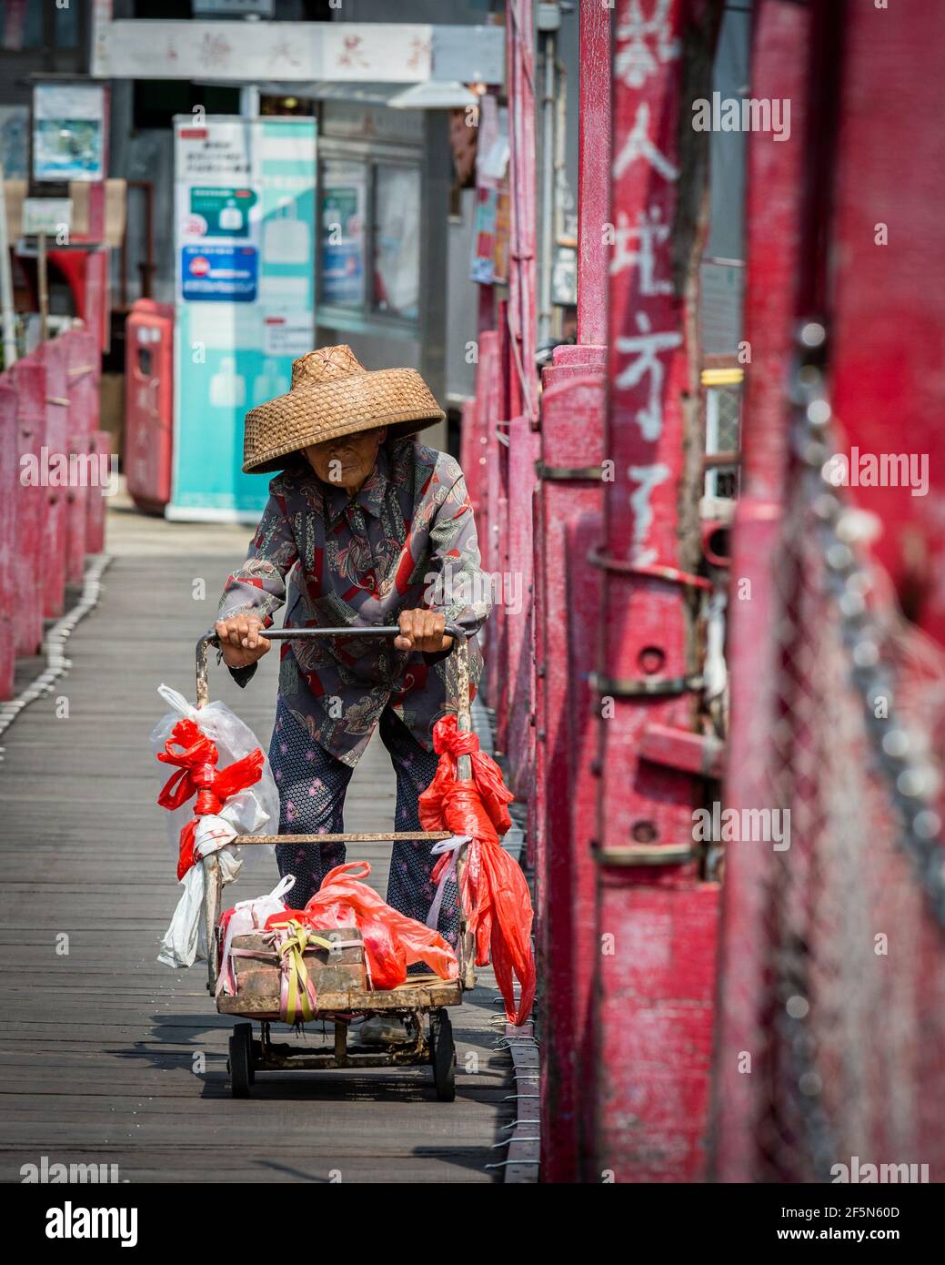 Old lady pushing cart in Tai O bridge Stock Photo - Alamy