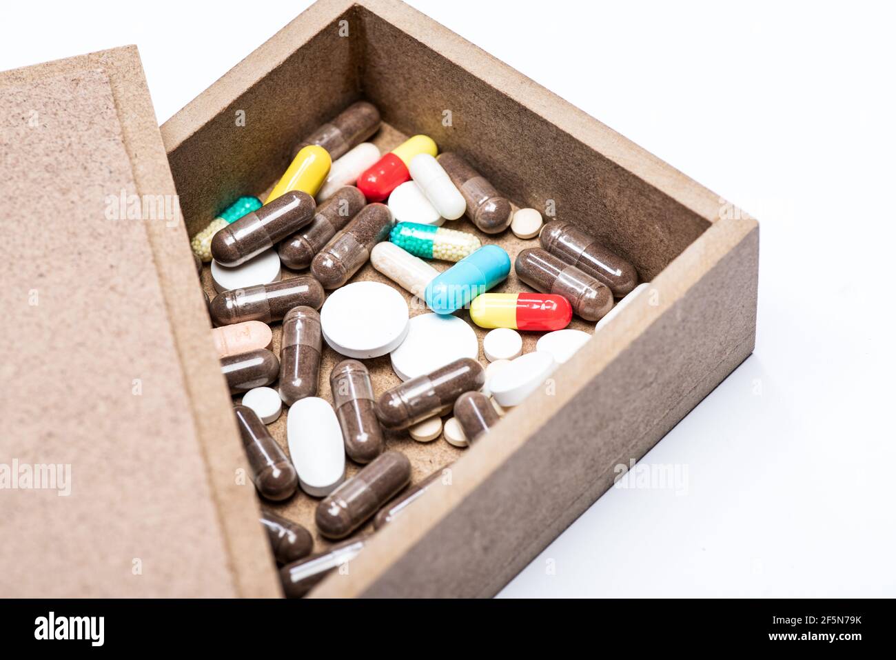 Prescription drugs of different shape and color in open pill box ...