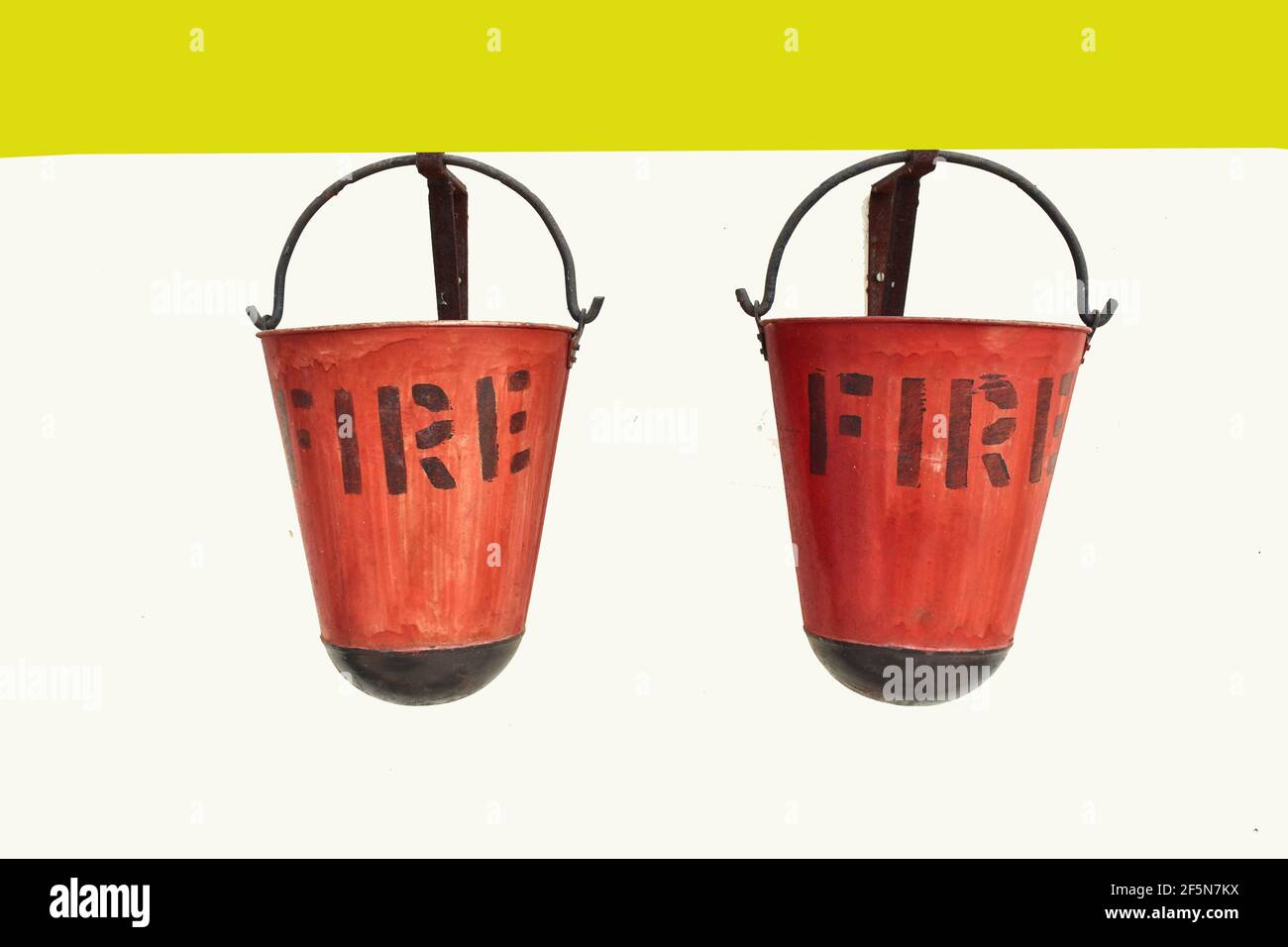 Closeup shot of two water buckets (fire safety equipment) on a wall ...