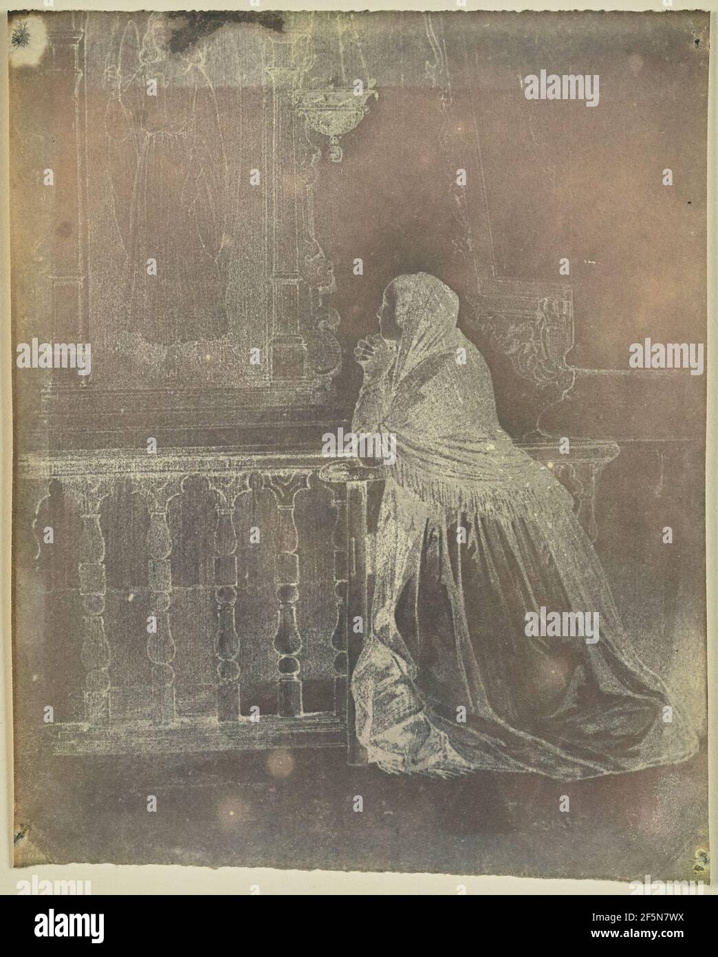 Woman praying at an altar Stock Photo - Alamy