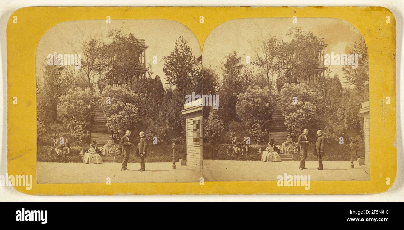 Two men standing, talking, group of people on steps in background, all ...