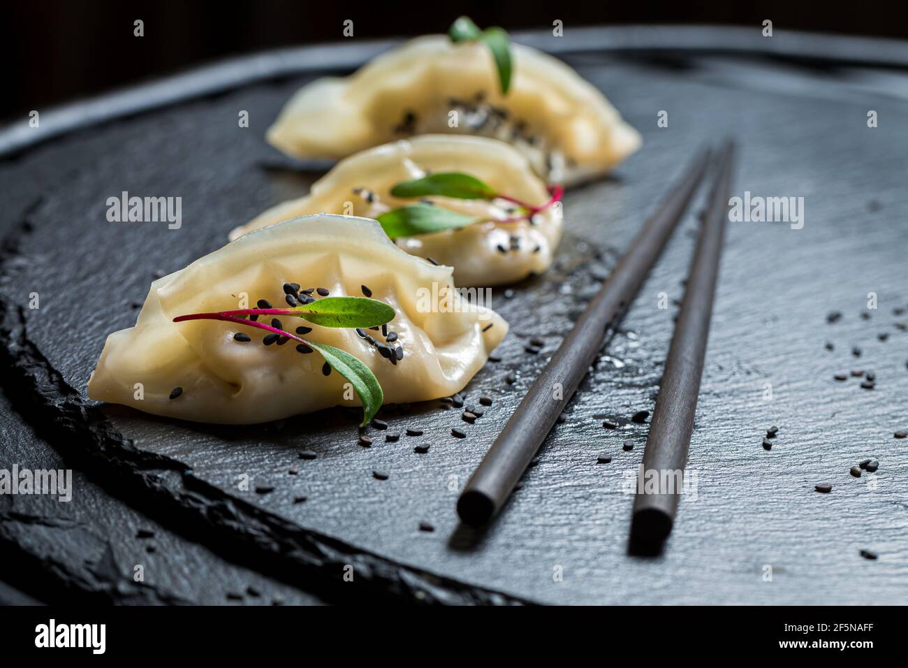 Enjoy your chinese dumplings on black rock. Old Chinese cuisine Stock ...