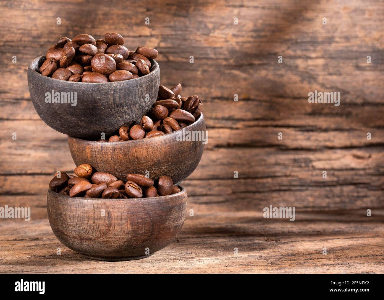 Freshly roasted coffee beans in small wooden bowls Stock Photo - Alamy