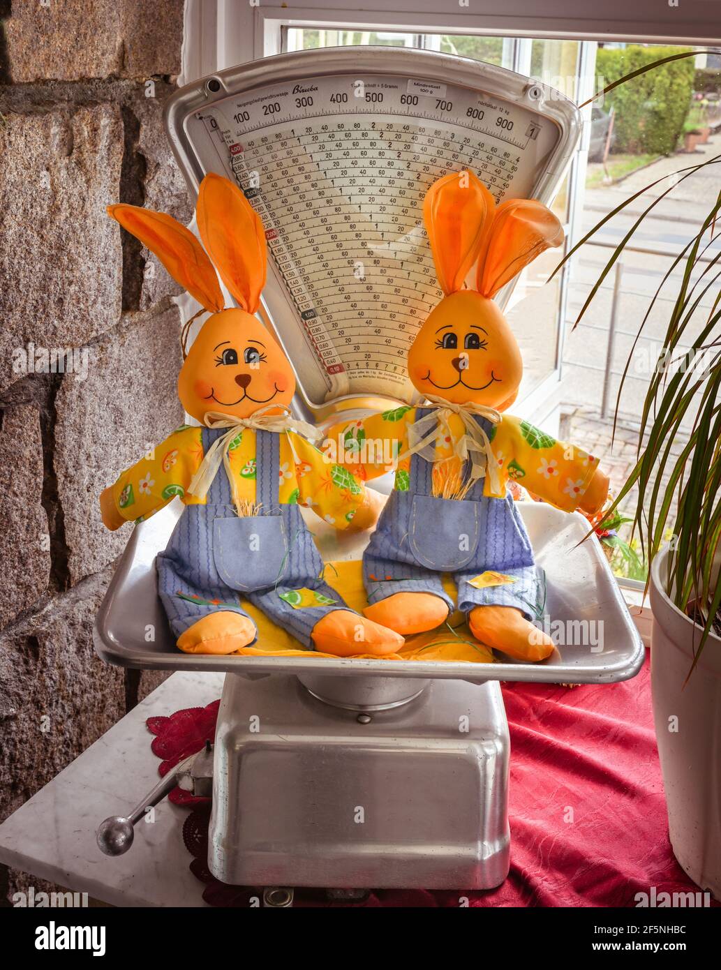 Two Easter bunnies on an old weighing machine Stock Photo - Alamy
