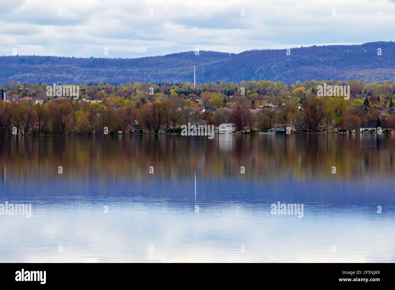 Landscape view across the river to Quebec where homes, forests and the ...