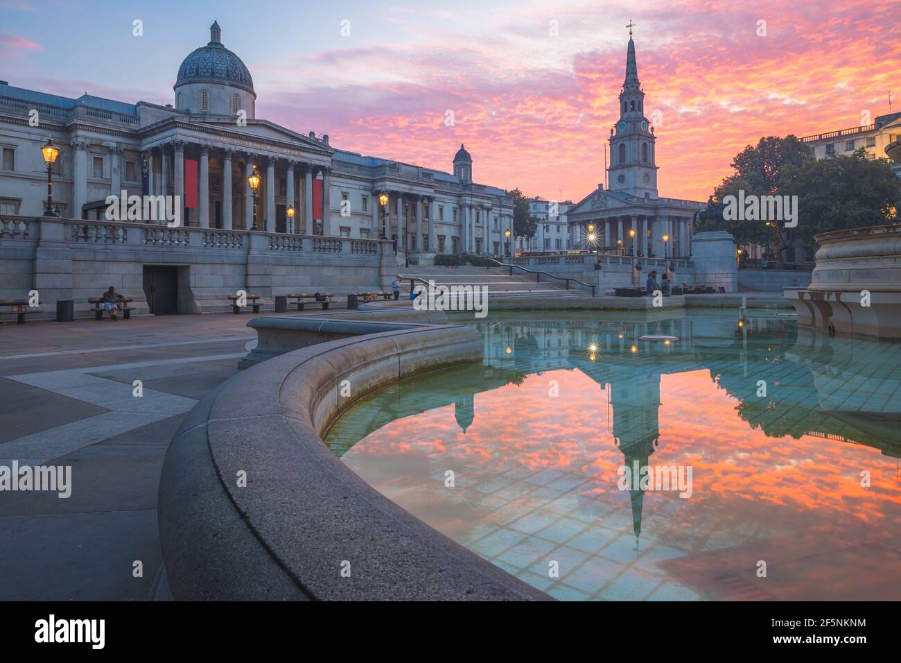 A vibrant colourful, dramatic sunrise or sunset sky at Trafalgar Square ...
