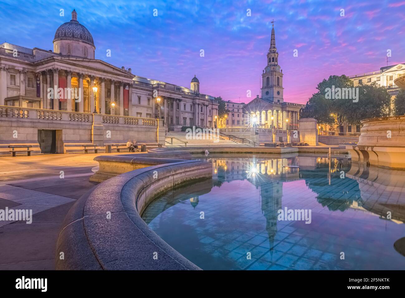 Night cityscape with a colourful, dramatic sky at sunrise or sunset at ...