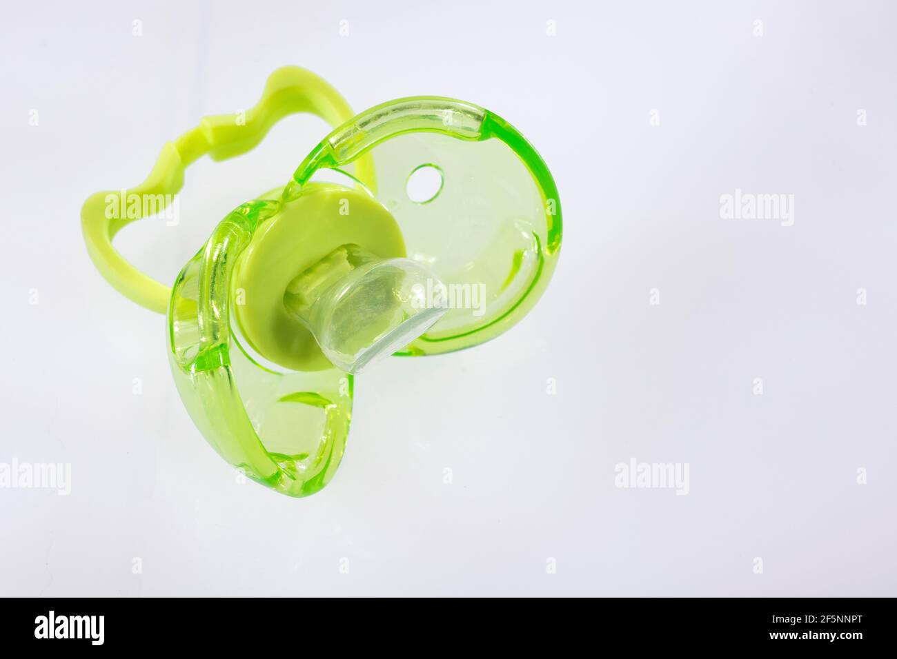 Green Plastic Baby Pacifier - White Background Stock Photo - Alamy