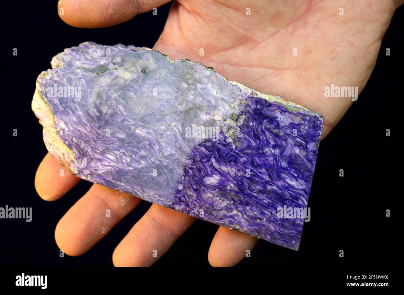 Man hands holding semi precious stone mineral Stock Photo - Alamy