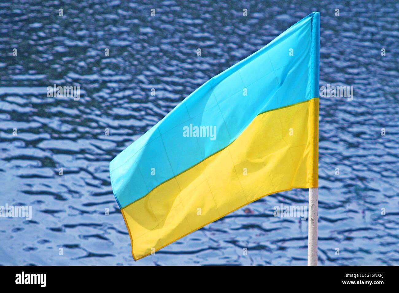 Ukrainian flag and water as background Stock Photo - Alamy