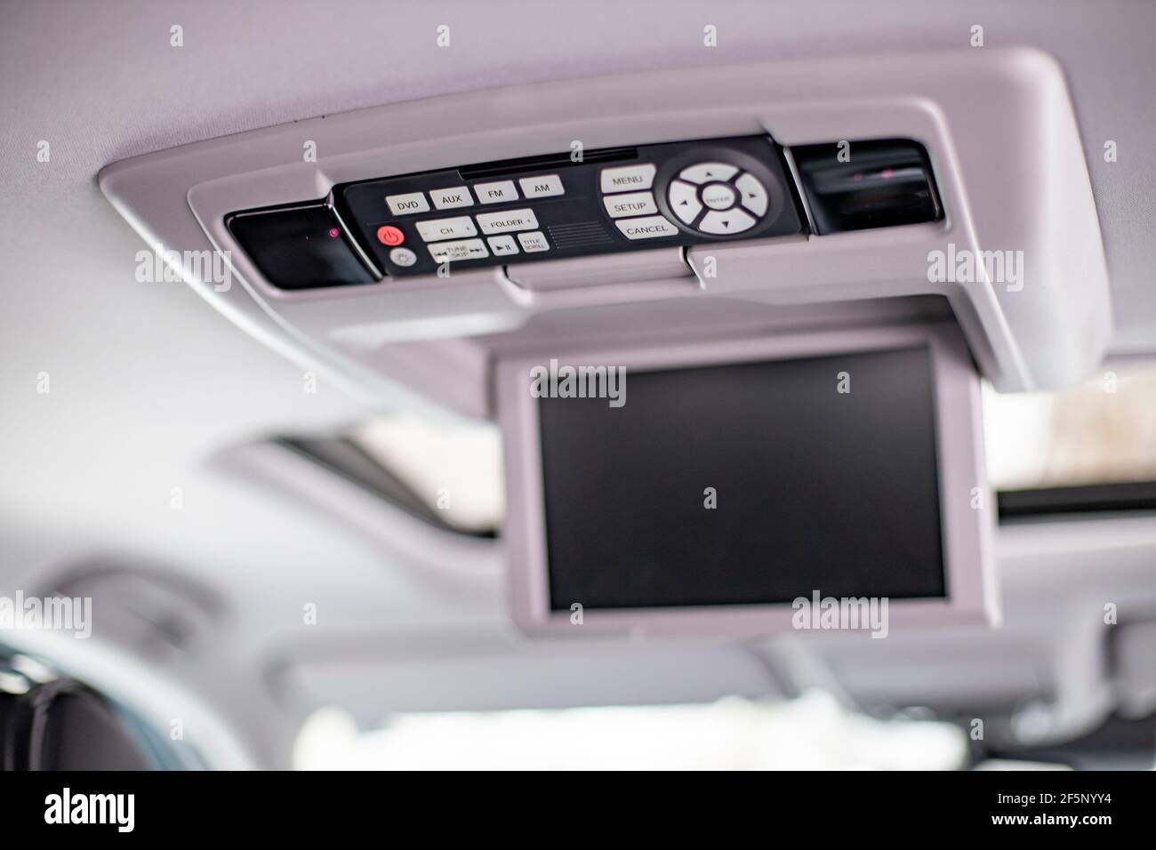 screen m multimedia system control panel on the ceiling of a modern car ...