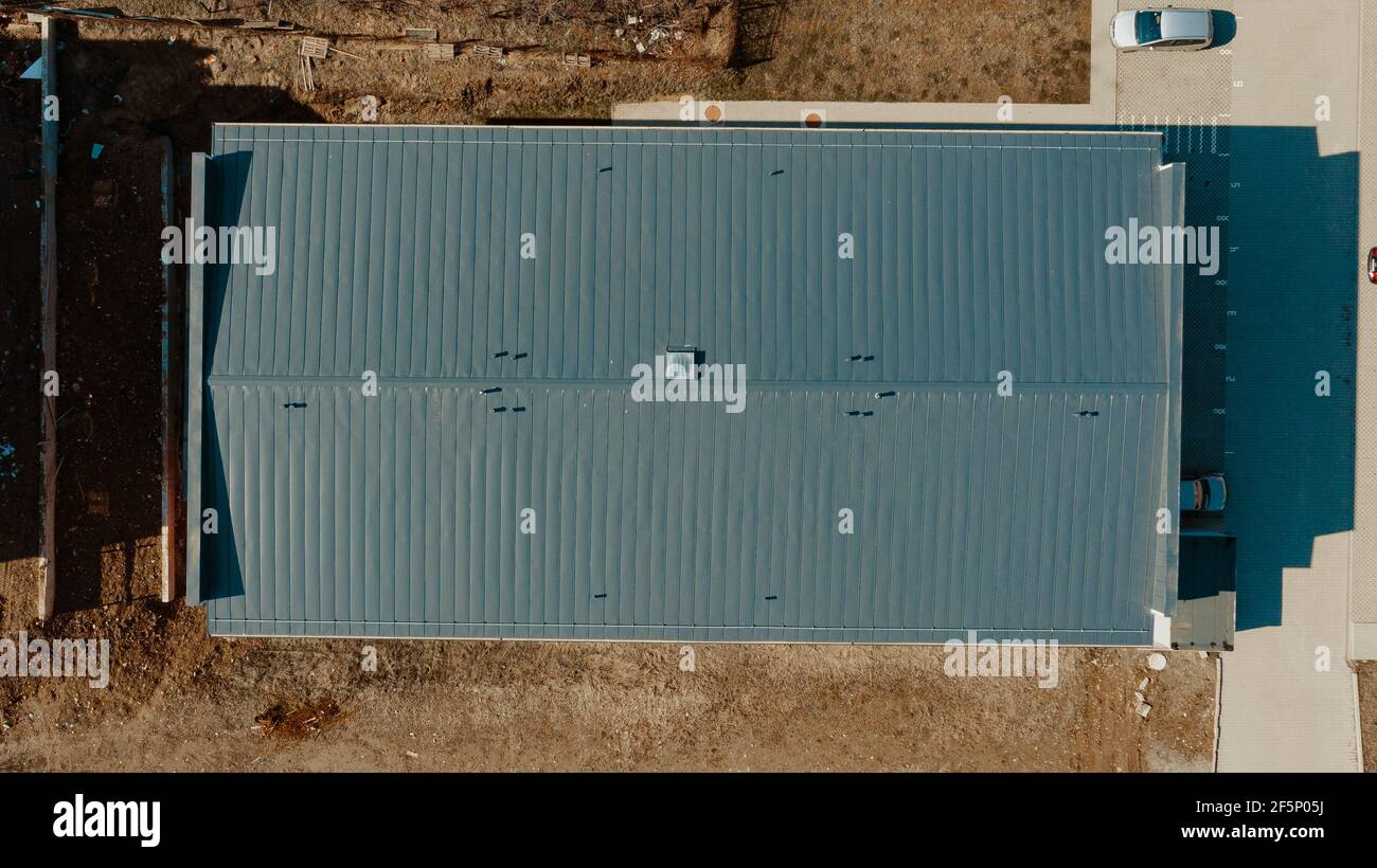 Top view from drone. New tin roof on the apartment building. Waterproof ...