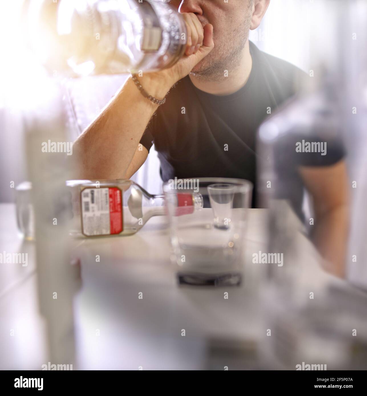 drunk man drinking vodka from a bottle Stock Photo - Alamy