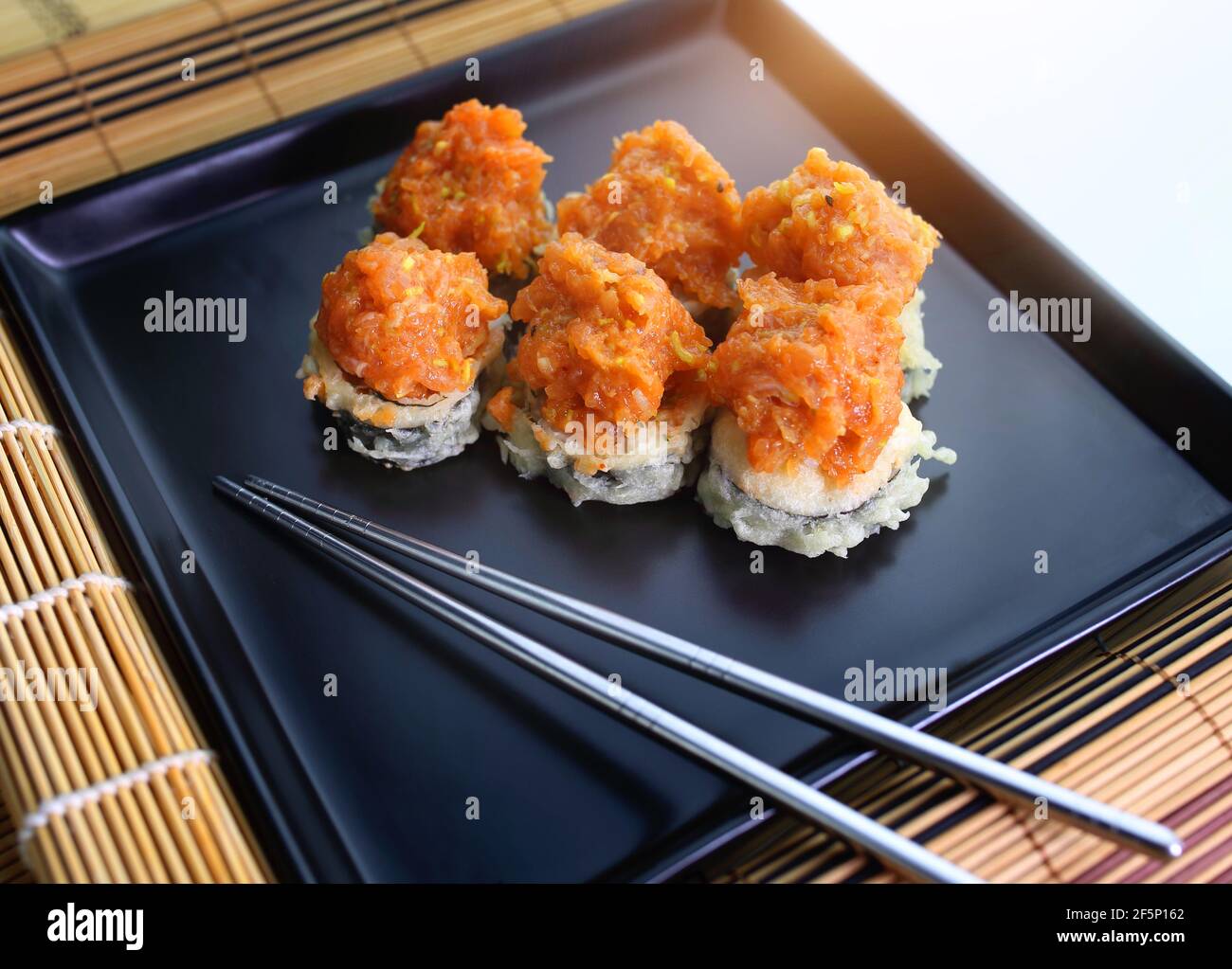 appetizing fish tartare sushi served nicely on a black plate Stock ...