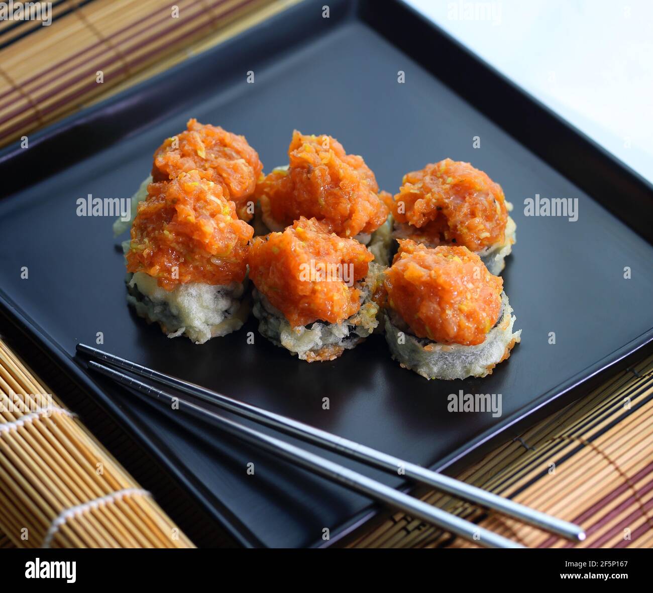 appetizing fish tartare sushi served nicely on a black plate Stock ...