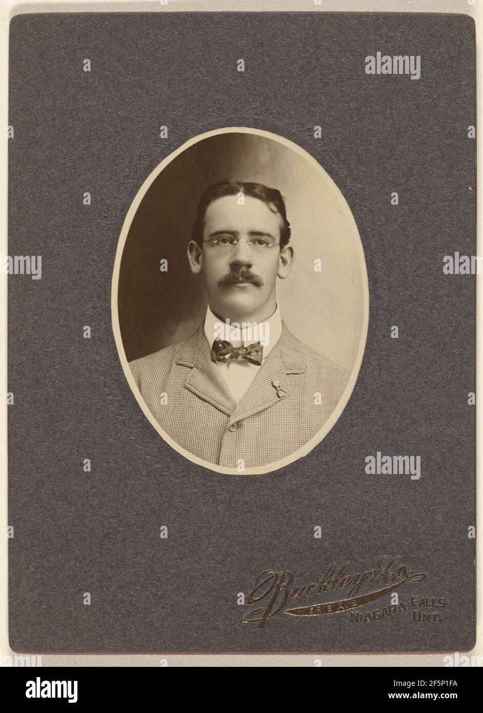Unidentified man with moustache wearing wire-rimmed glasses. Buckley ...
