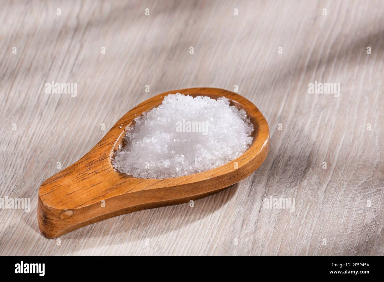 Magnesium chloride in wooden spoon - Text space Stock Photo - Alamy