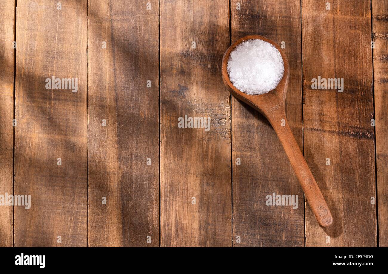 Magnesium chloride in wooden spoon - Text space Stock Photo - Alamy
