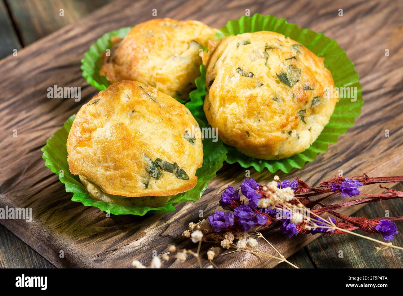 Delicious swiss chard muffins with cheese - Wood background Stock Photo ...