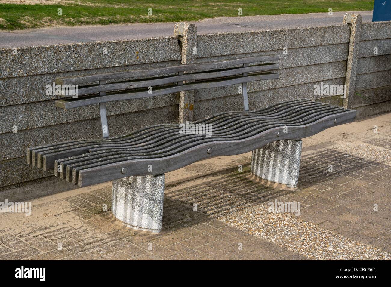 A wooden bench at a Norfolk beach in the shape of the waves Stock Photo ...