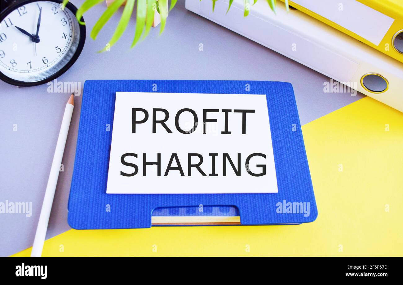 Text sign Profit sharing words written on white paper above Notebook ...