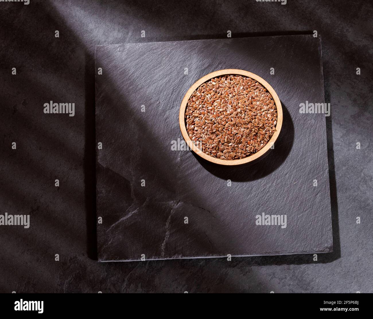 Linum usitatissimum - Organic flax seeds. Text space Stock Photo - Alamy