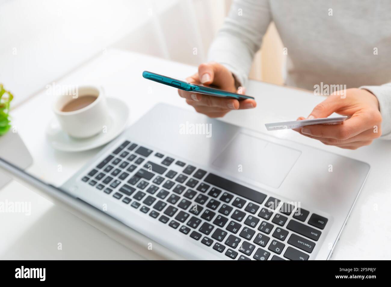 Using a credit card and phone to make online purchases in an online ...