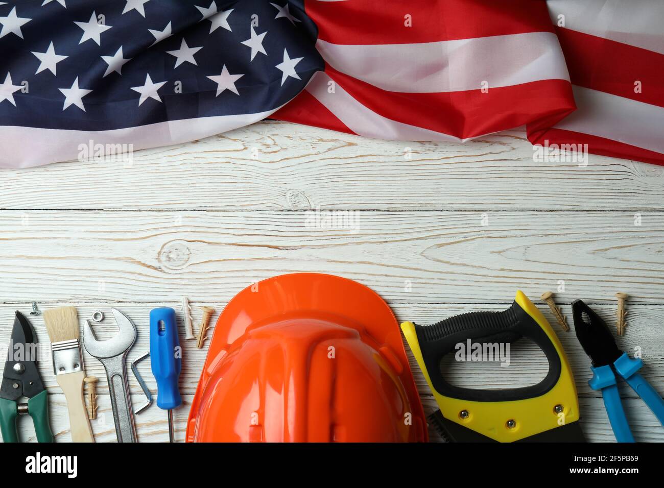 Concept of Labor Day with different construction tools on white wooden ...