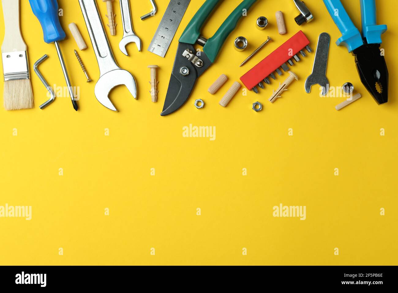 Different working tools on yellow background, space for text Stock ...