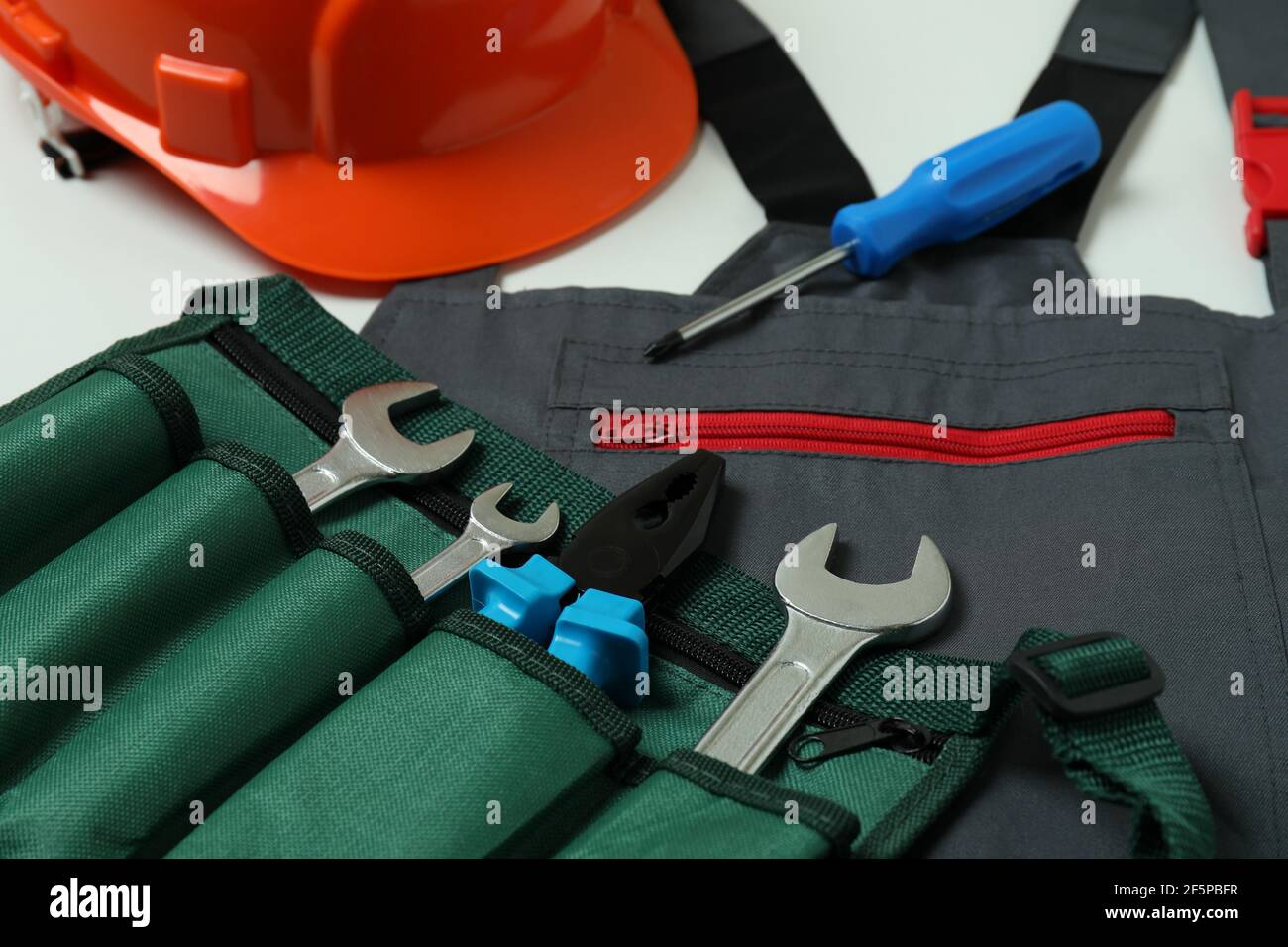 Overalls, hard hat and working tools, close up Stock Photo - Alamy