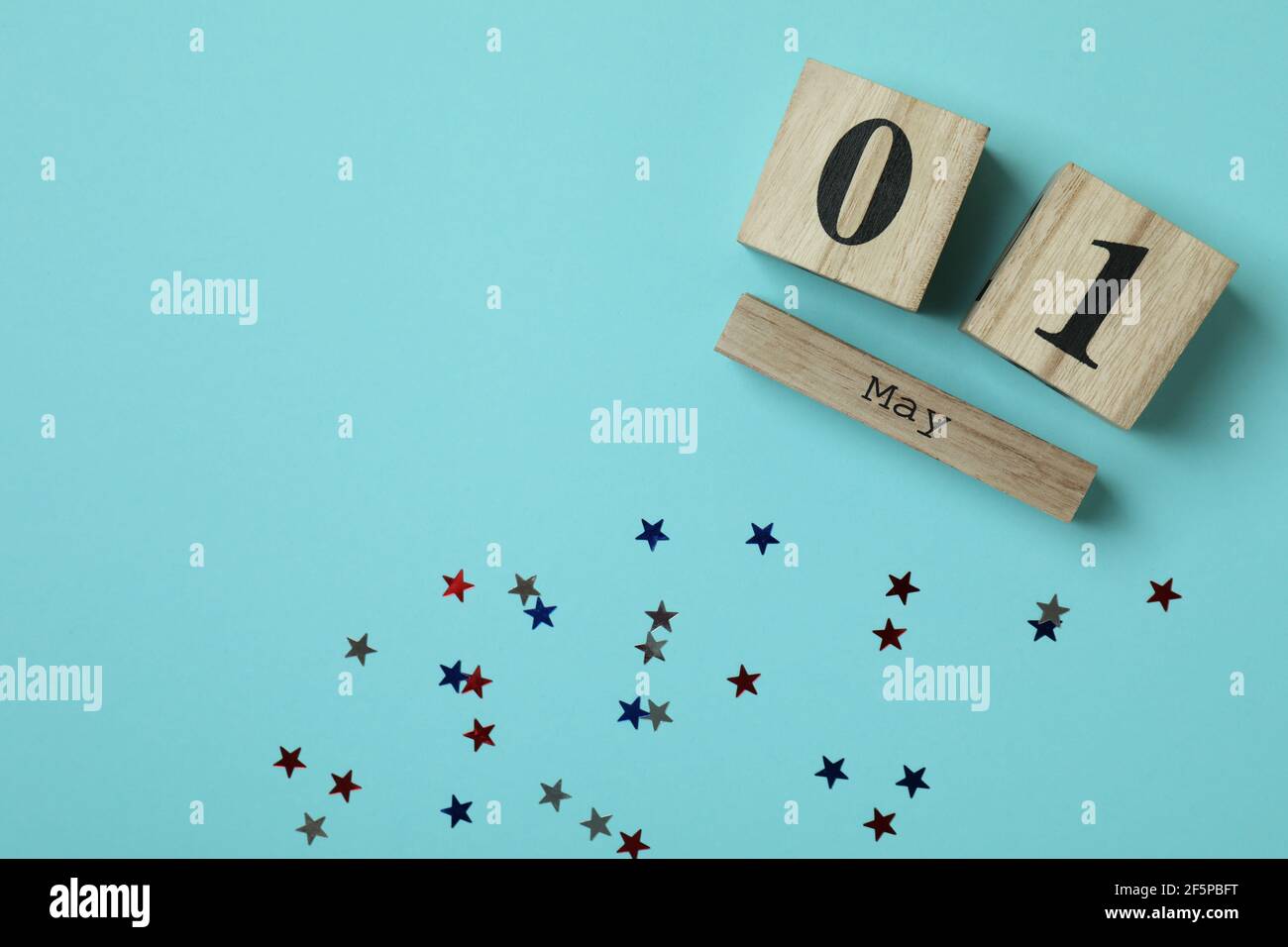 Wooden calendar with 1 may and glitter on blue background Stock Photo ...