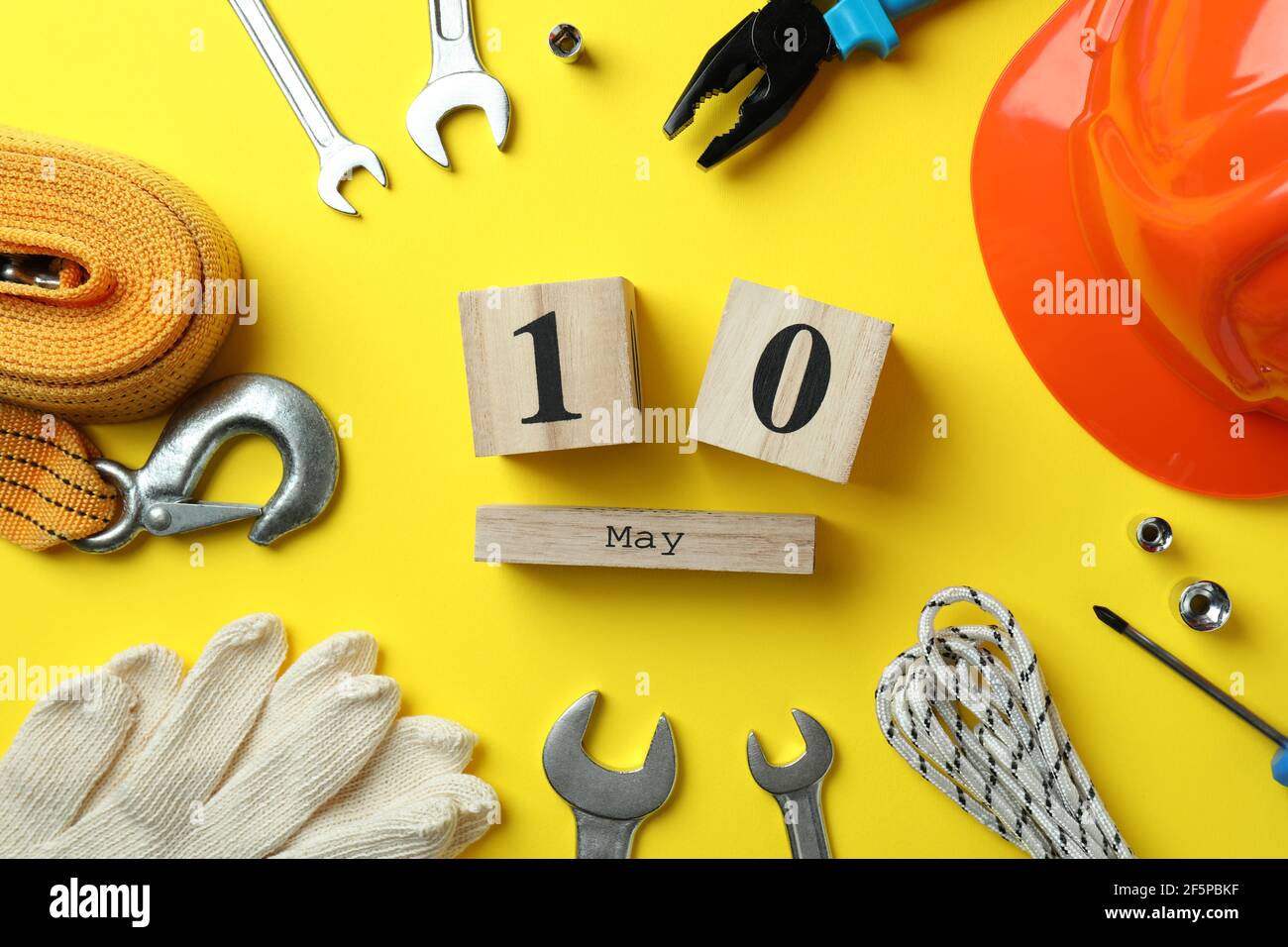Wood calendar with 1 mat and working tools on yellow background Stock ...