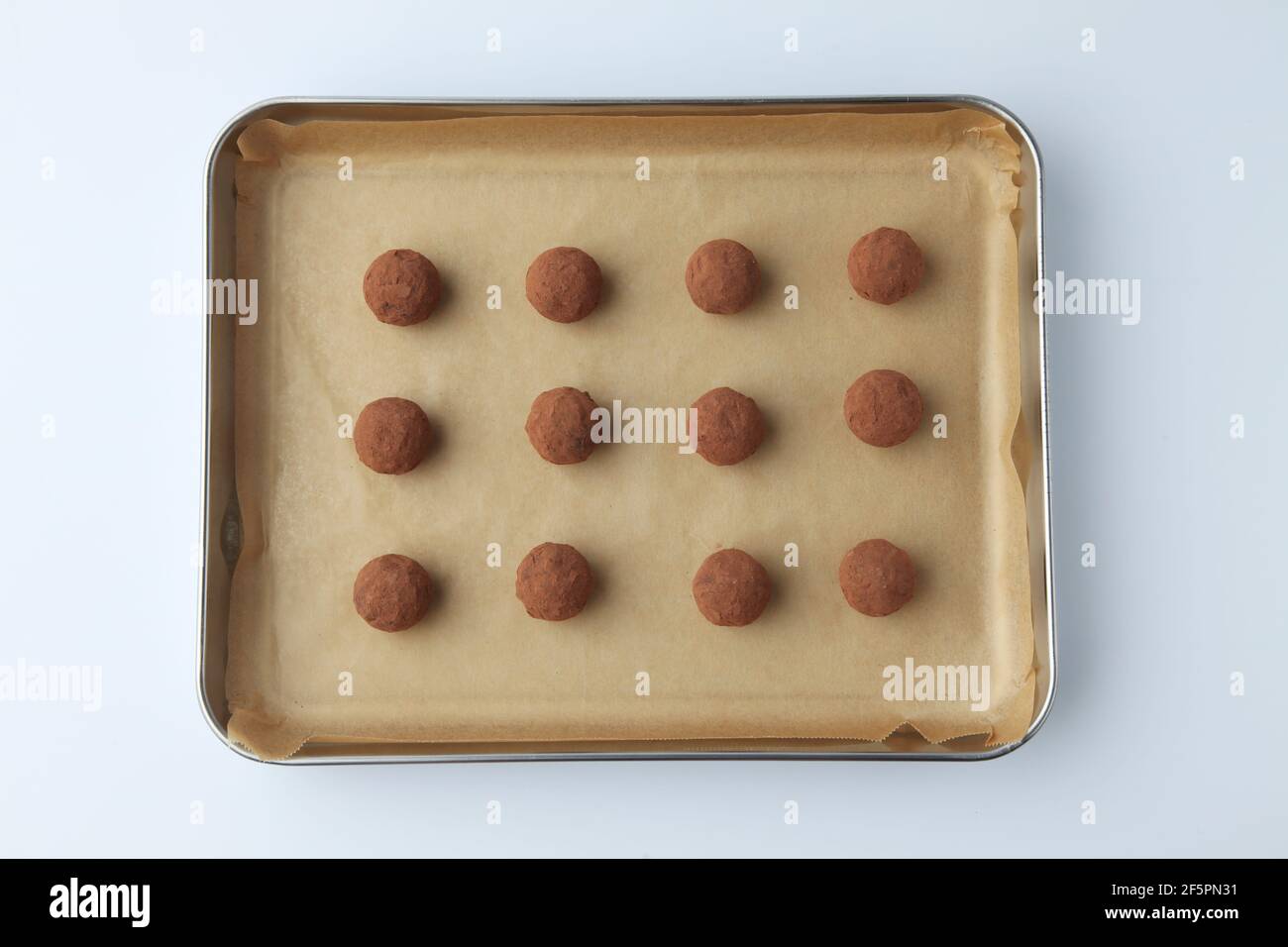 chocolate truffles on silver plate on white background Stock Photo - Alamy