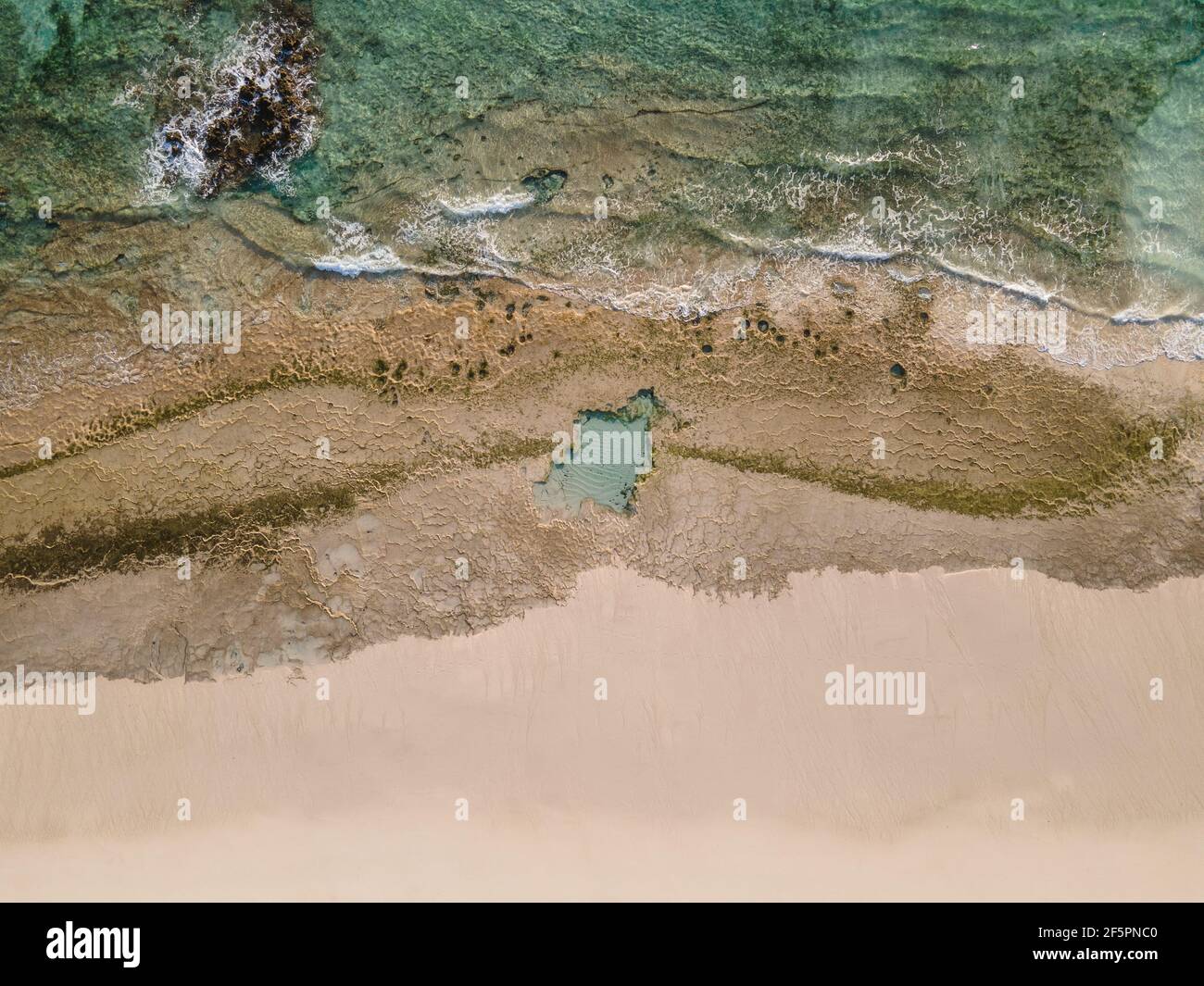 Sandy and rocky beach background overhead aerial shot. White sand ...