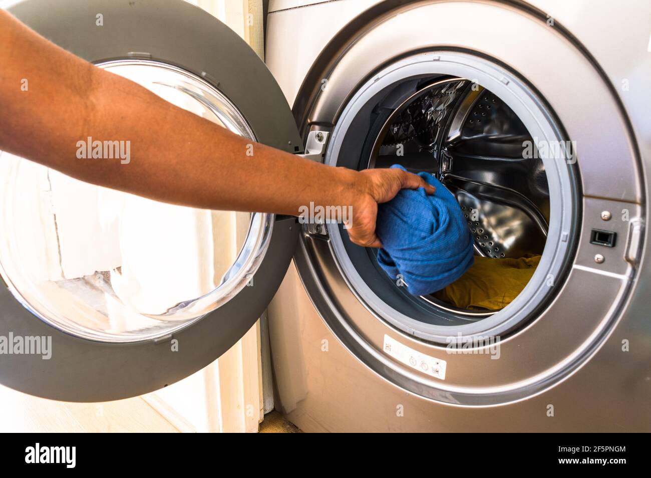 Loading washing machine hi-res stock photography and images - Alamy