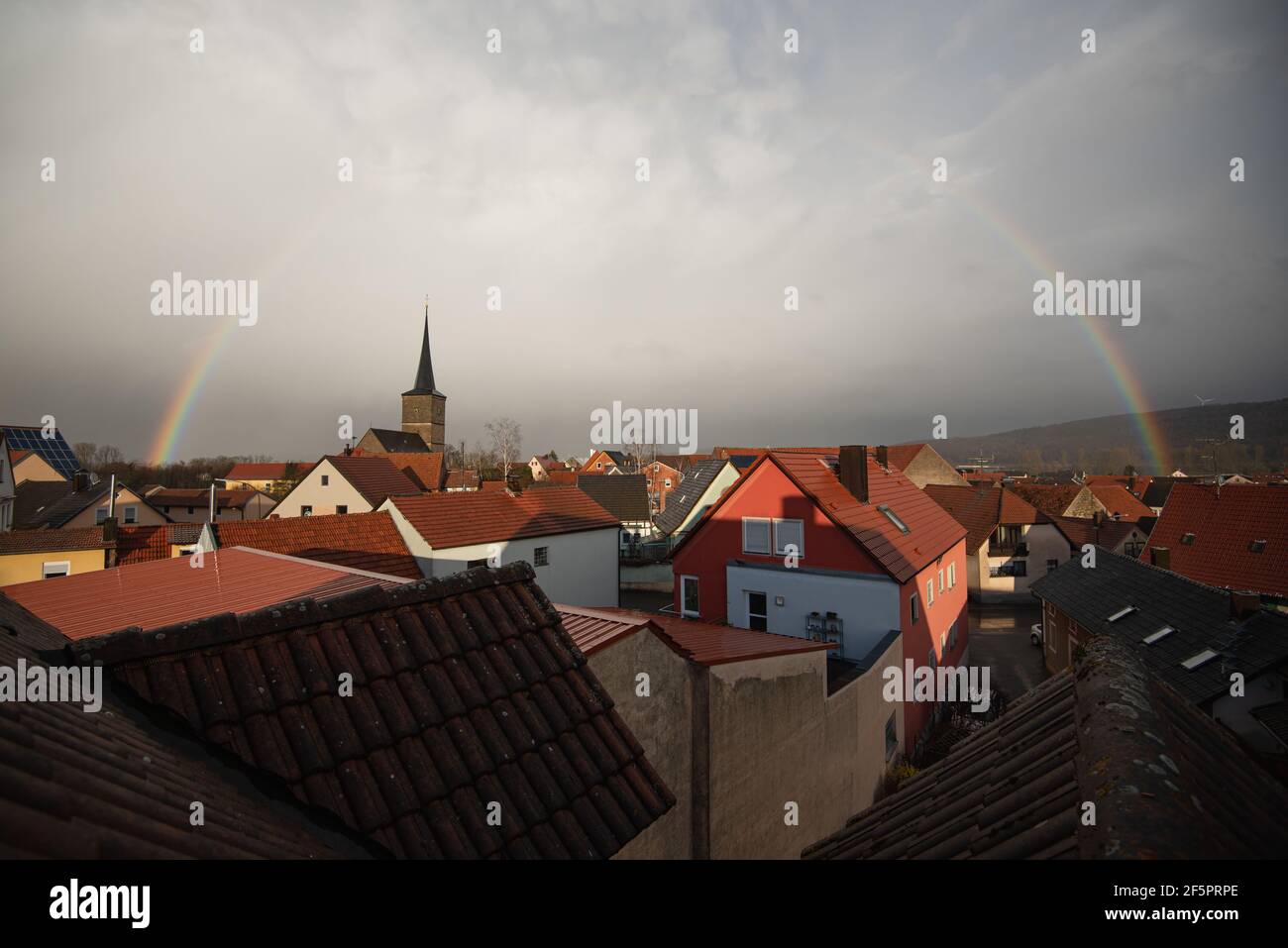 Ebing, Germany. 27th Mar, 2021. A rainbow shines behind St. James ...