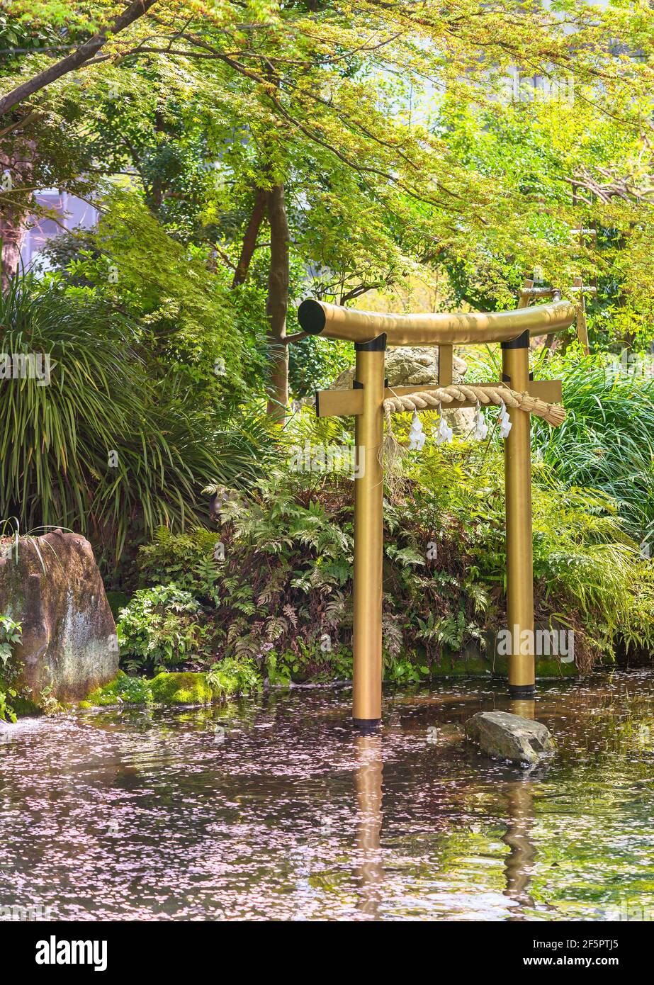 tokyo, japan - march 25 2021: Golden torii gate adorned with a ...