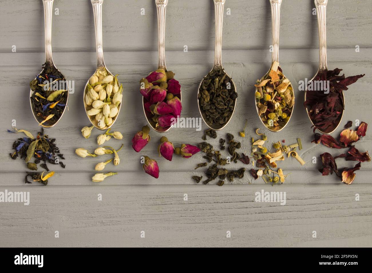 Tea composition.Different varieties of tea in the silver spoons on the ...