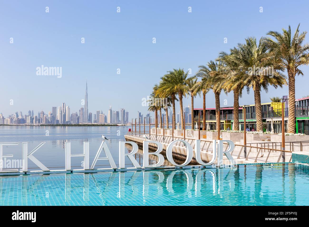 Dubai, UAE, 22.02.2021. Dubai Creek Harbour sign by turquoise water ...