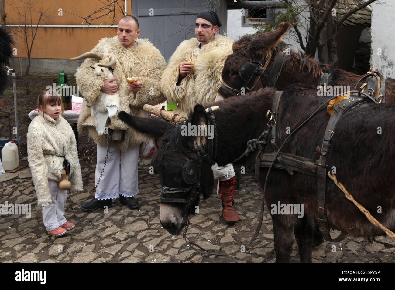 Masked Busós prepare for the carnival procession in the courtyard of ...