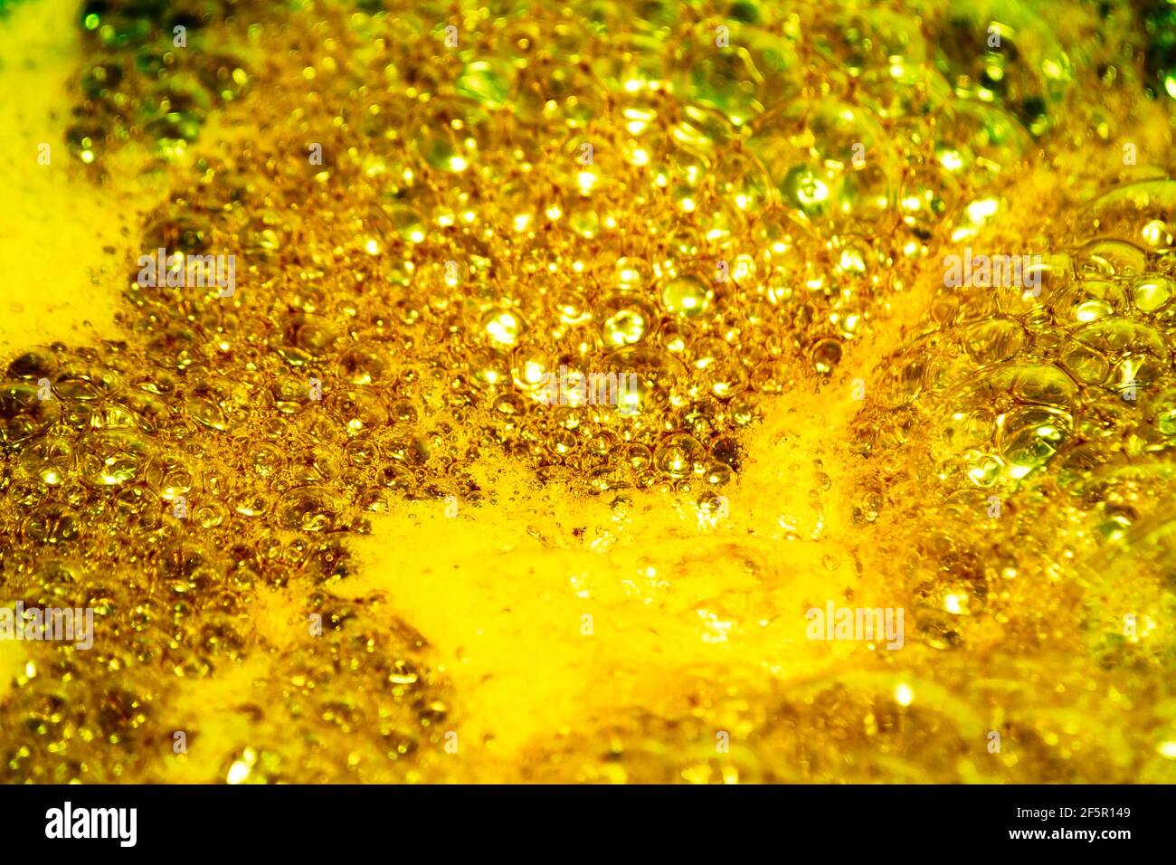 Golden foam. Background and texture concept. Close up of bubbling ...