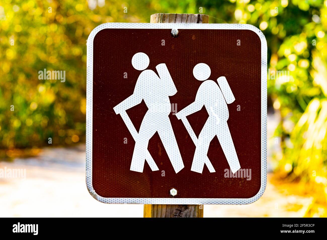 Florida park sign with two hikers used to designate a hiking trail in ...