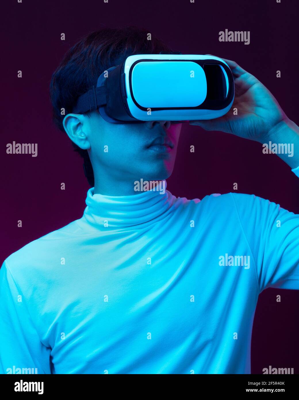 Young asian man wearing virtual reality goggles watching 360 degree ...