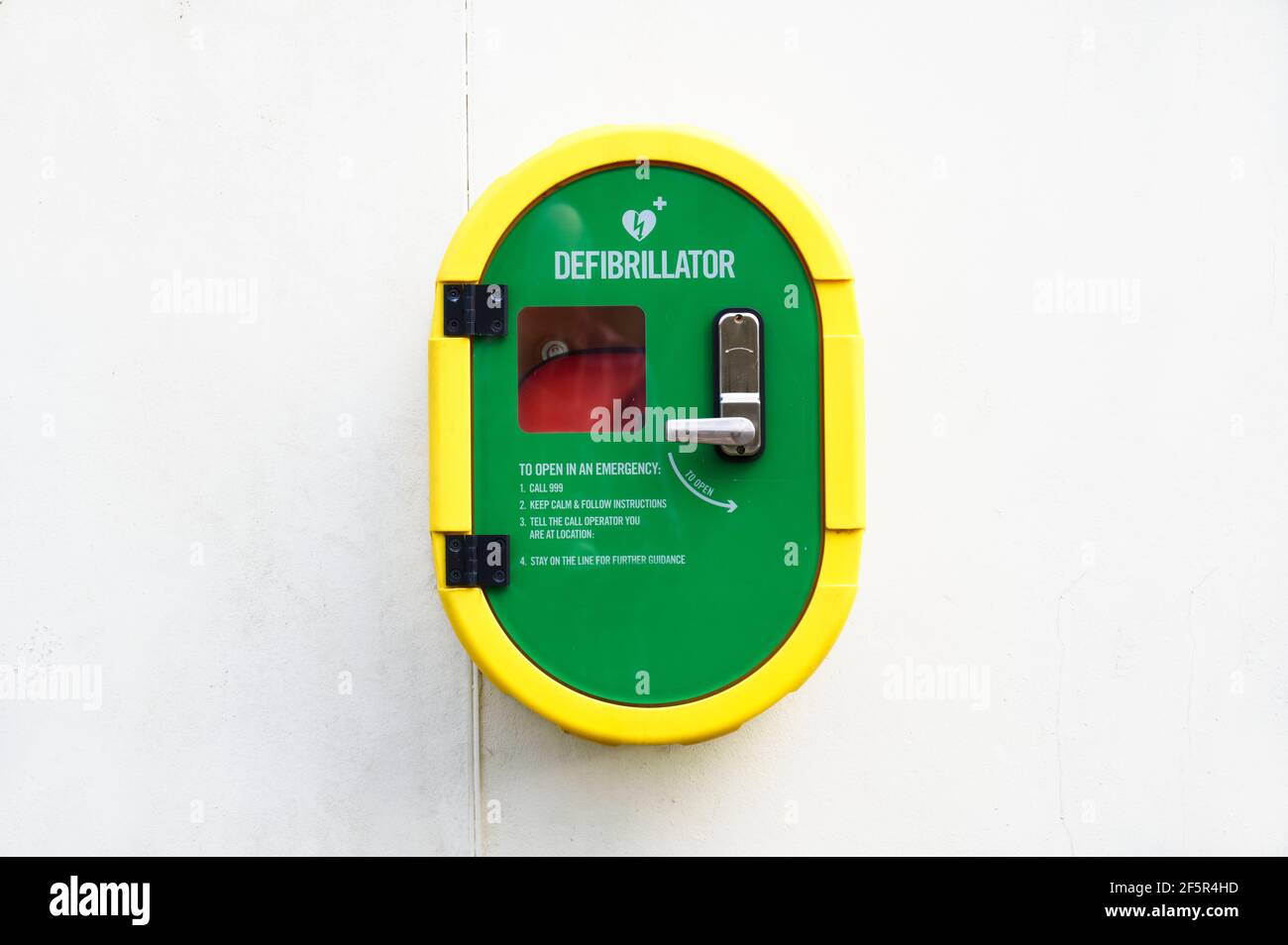 Defibrillator AED on wall in public space for emergency heart ...